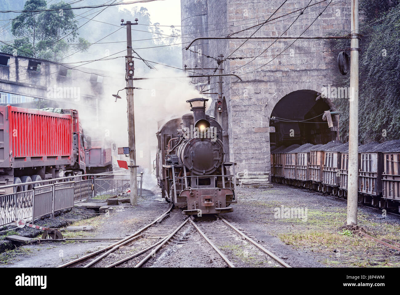Steam narrow-gauge locomotive stands by the coal loading point. Sichuan ...