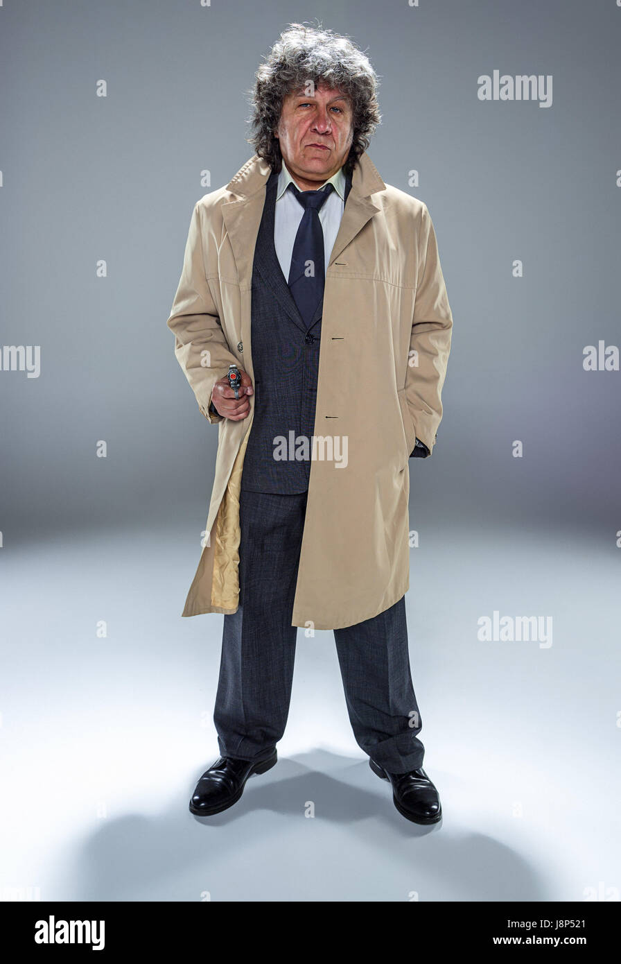 Senior police agent with a gun on dark smoke background Stock Photo - Alamy