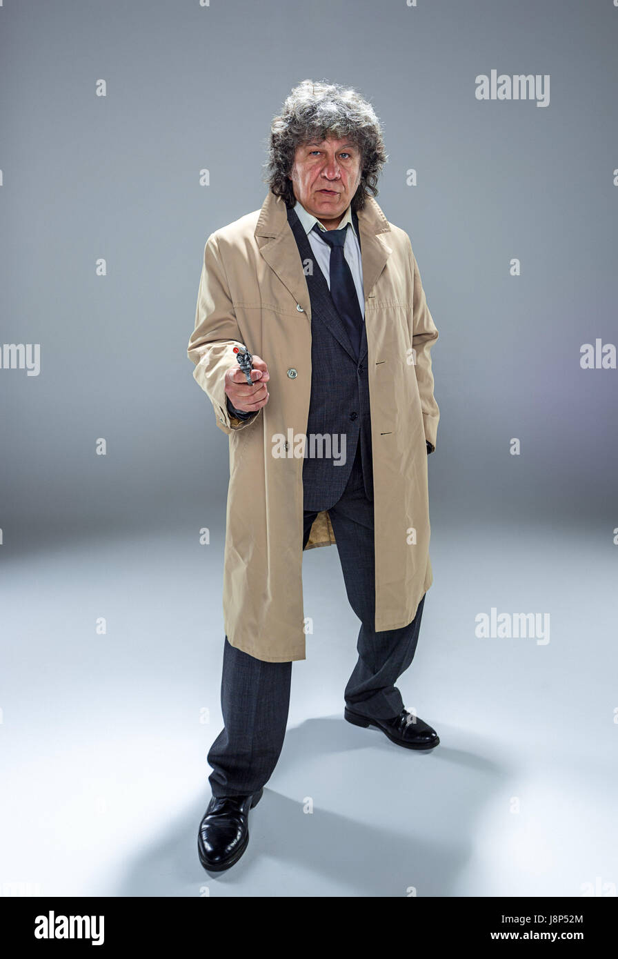 Senior police agent with a gun on dark smoke background Stock Photo - Alamy