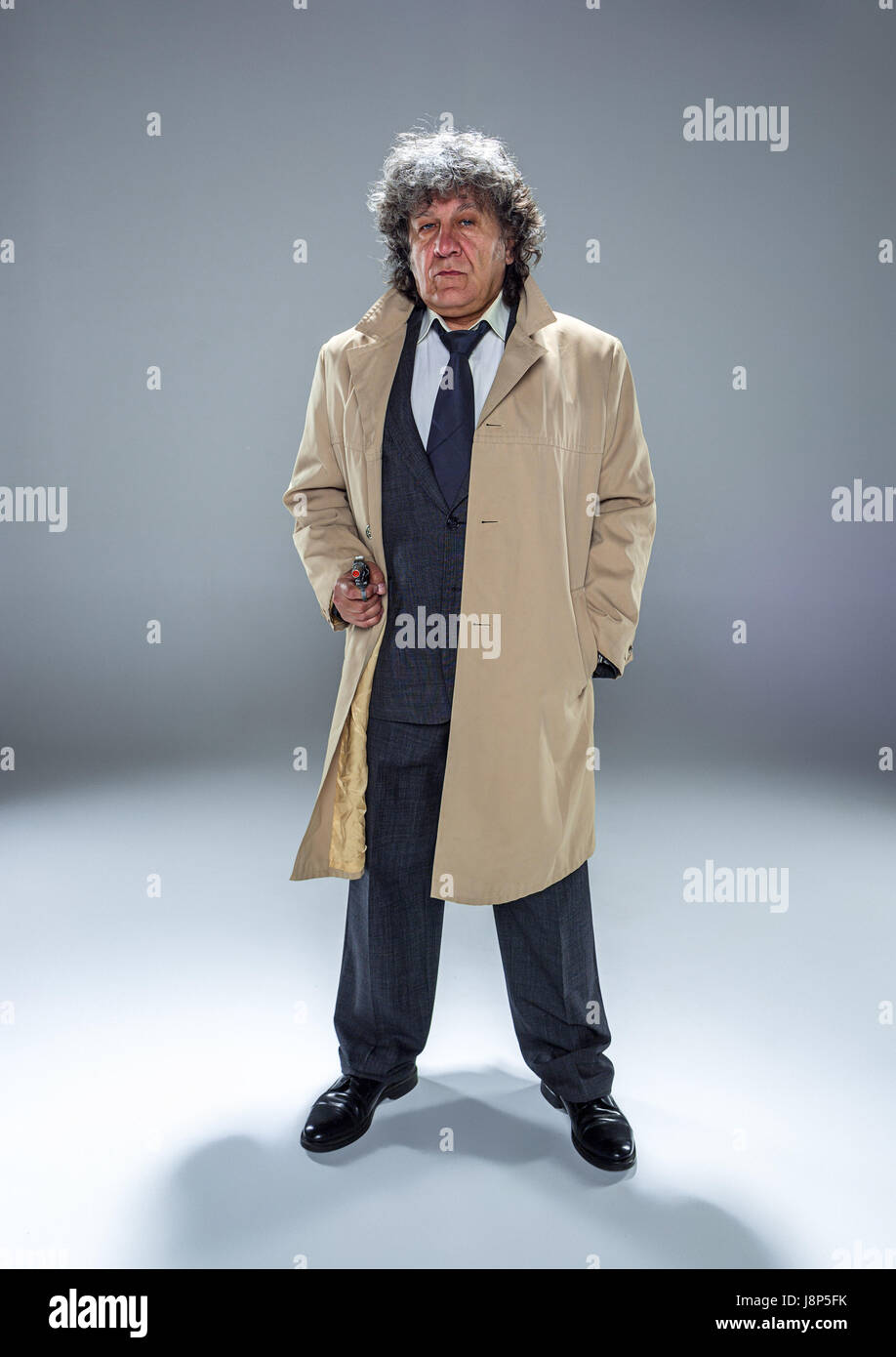 Senior police agent with a gun on dark smoke background Stock Photo - Alamy