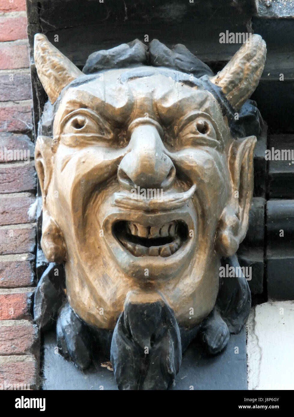 gargoyle devil face on a wall in york Stock Photo - Alamy