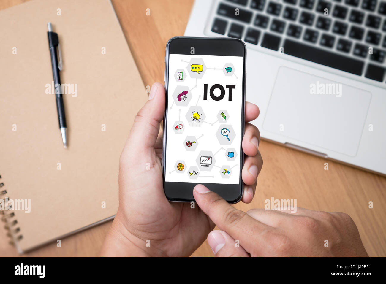 IOT business man hand working and internet of things (IoT) word diagram ...