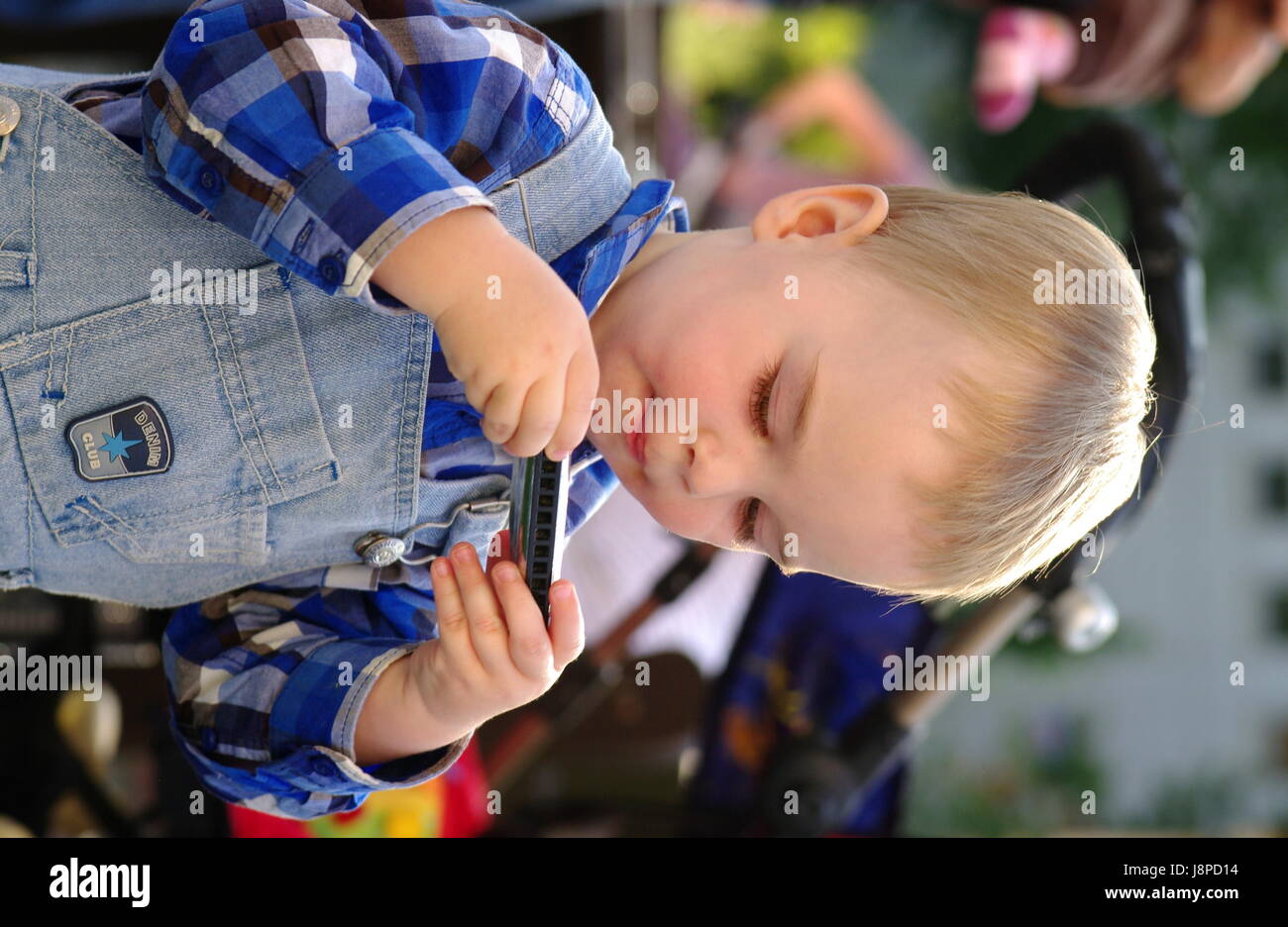 Boy playing harmonica hi-res stock photography and images - Alamy