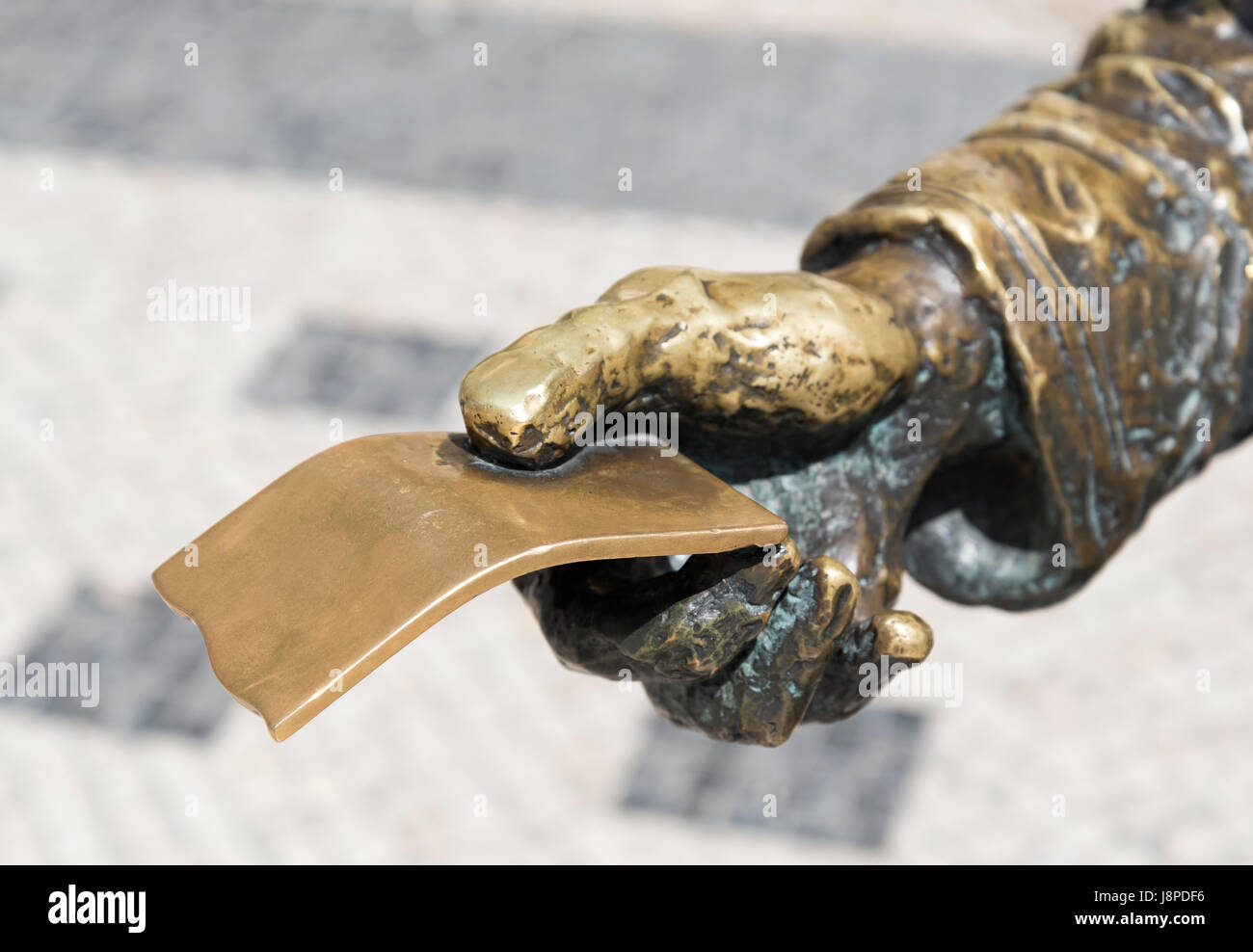 Close-up of bronze statue of a man holding a lottery ticket, Lisbon ...
