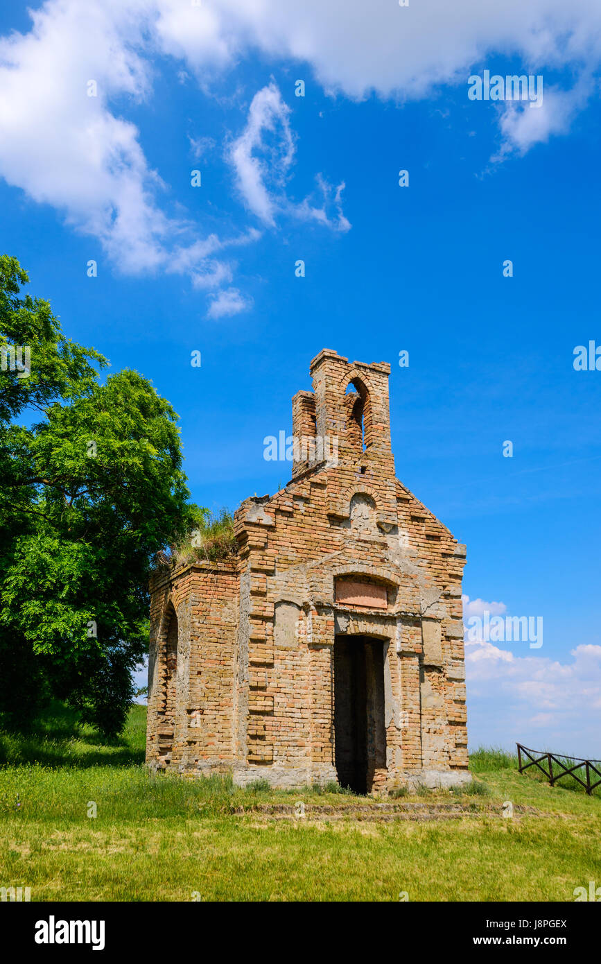 Remains of old ruined monastery church on the hill above small town of ...