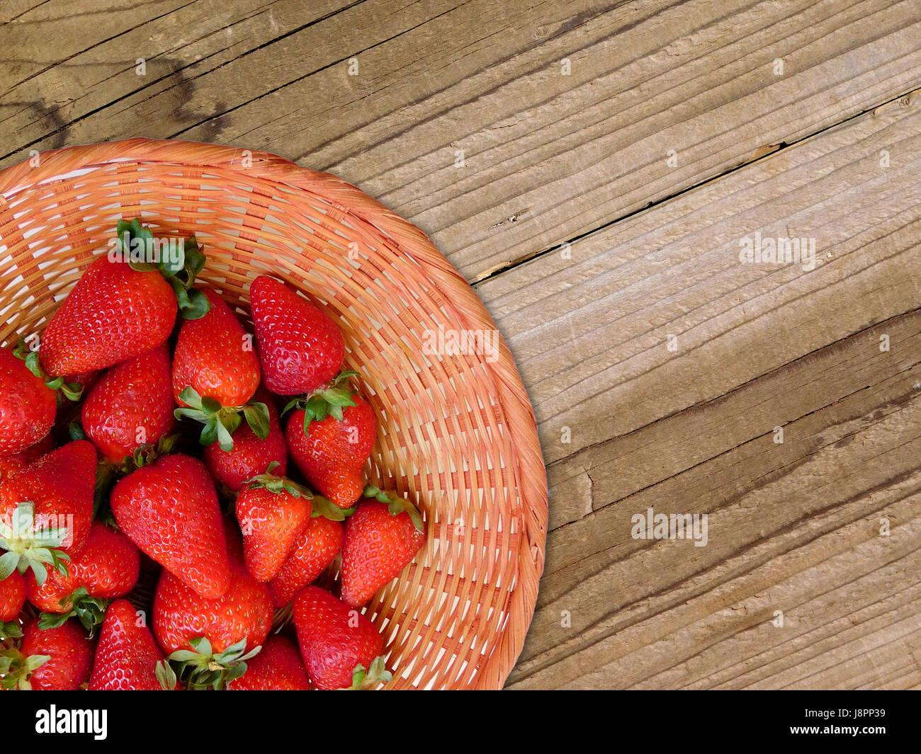 Strawberries on wooden background Stock Photo - Alamy