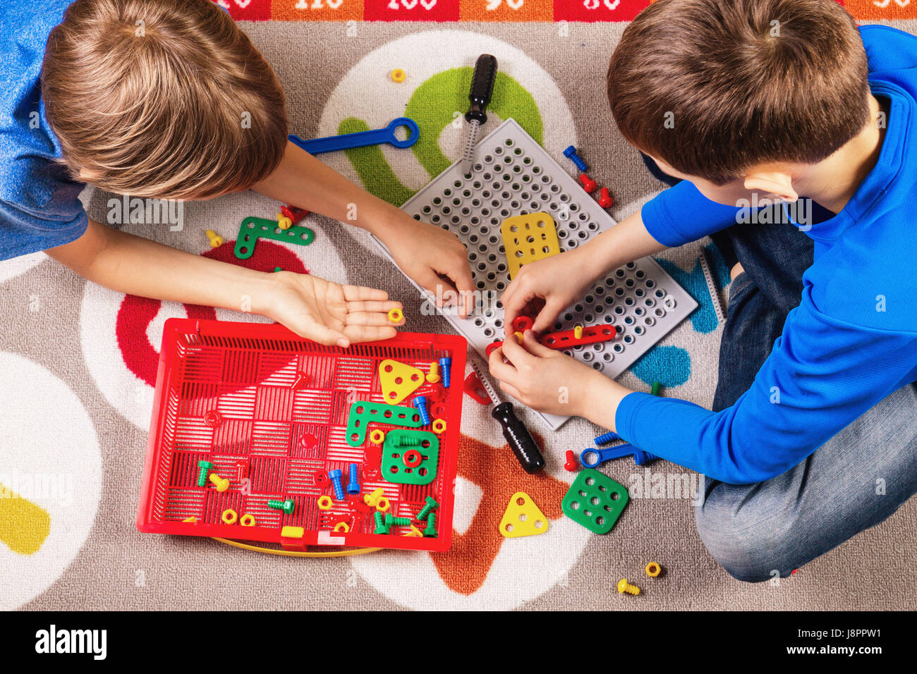 Kids playing with toys tool kit.Top view Stock Photo - Alamy