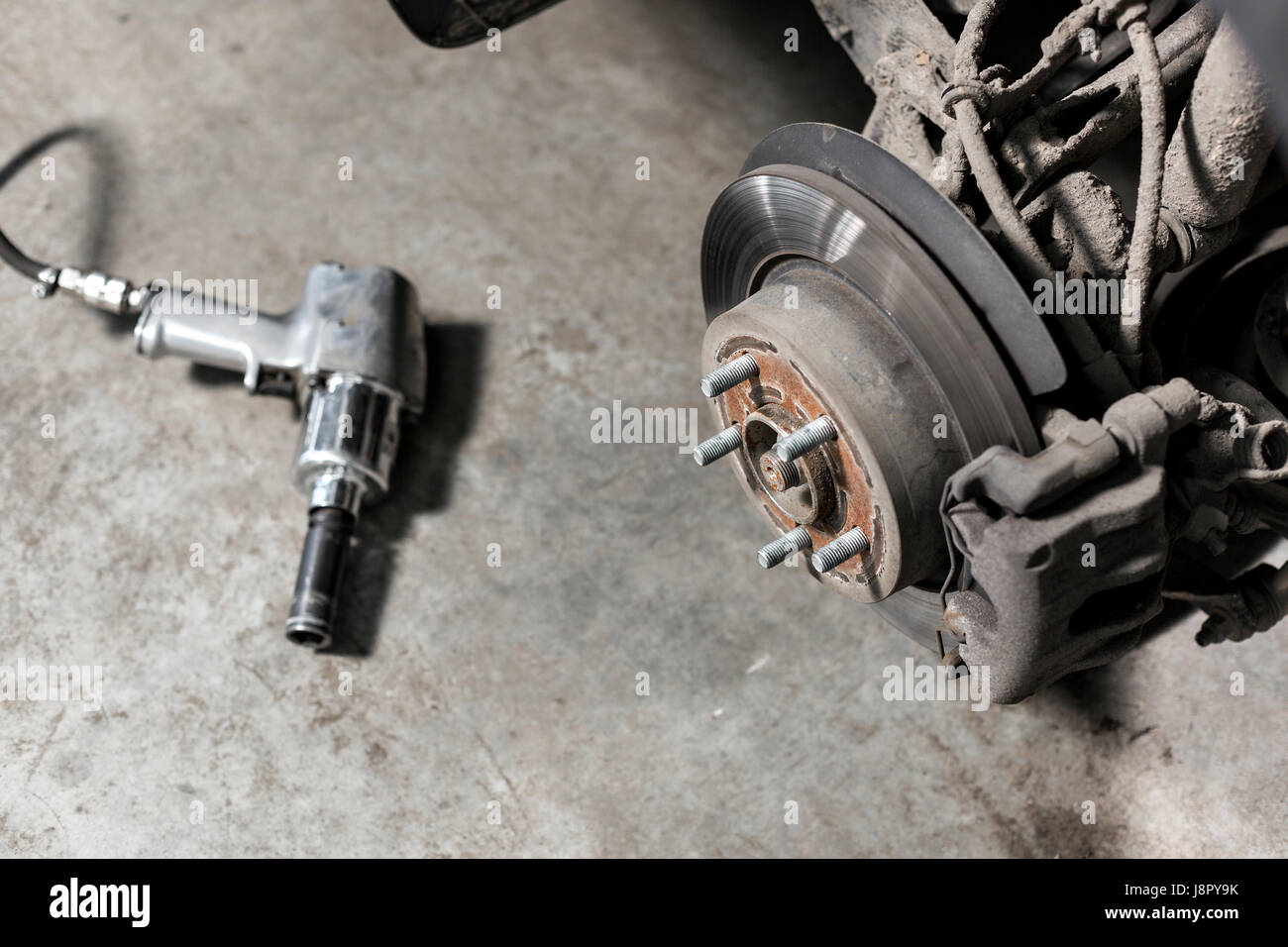 Closeup disc brake of the vehicle for repair. shot wheel, the tool for ...