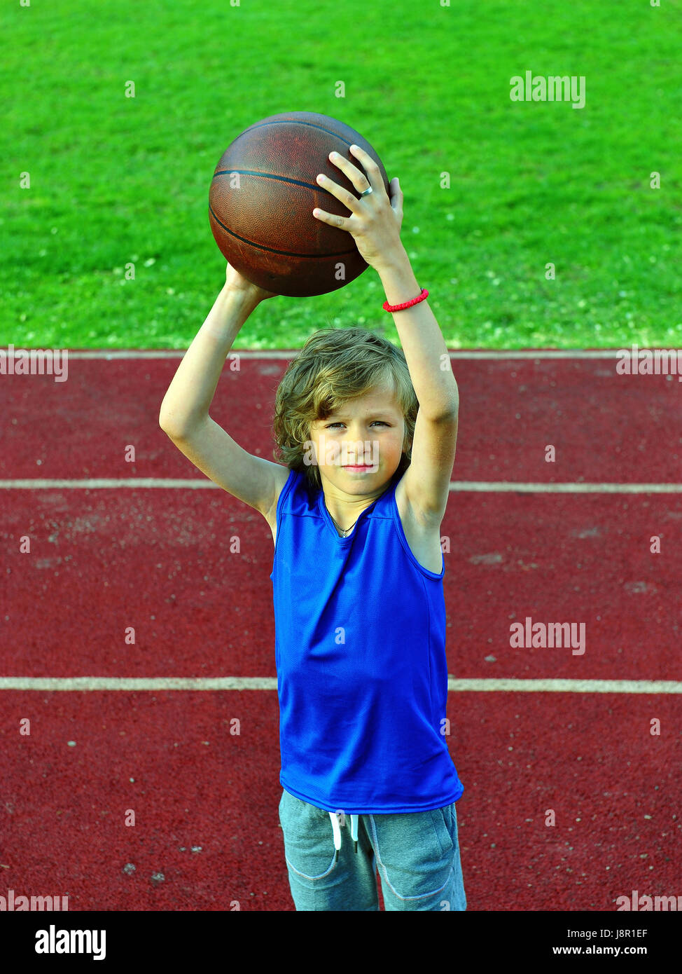 Little basketball player preparing to throw a ball Stock Photo - Alamy