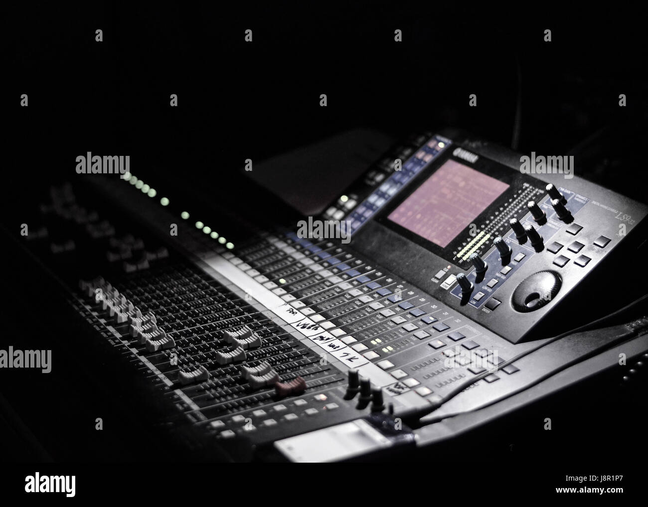sound desk at life gig lamp lit in darkness Stock Photo - Alamy