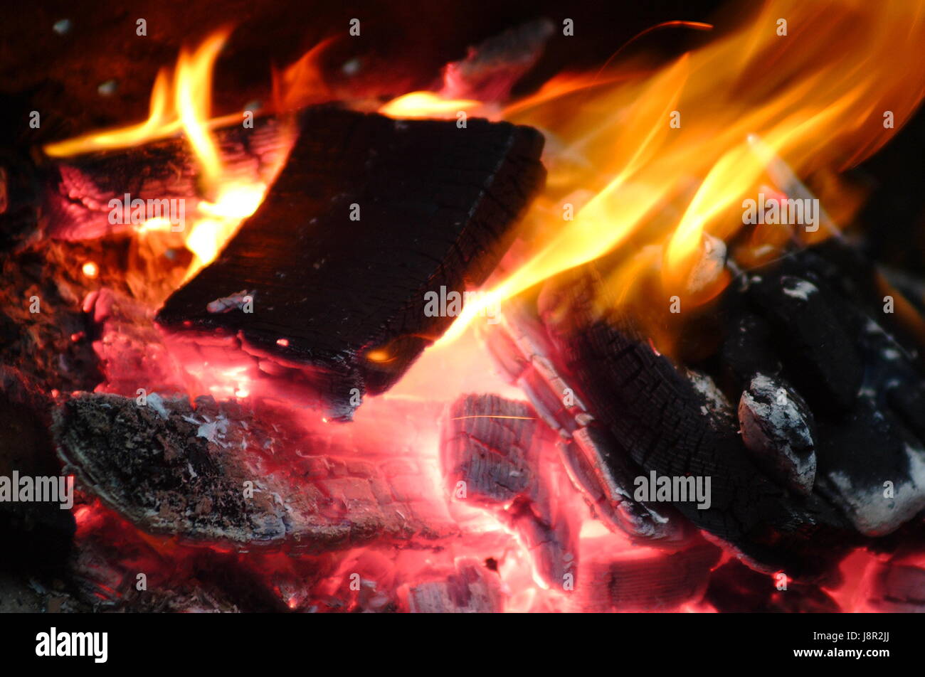 Burning wooden log flame on fire in fireplace Stock Photo - Alamy
