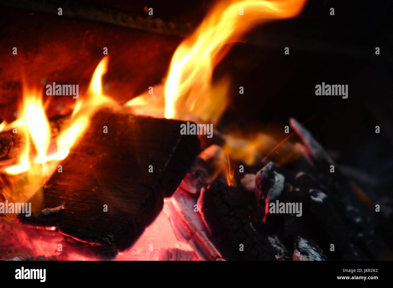 Burning wooden log flame on fire in fireplace Stock Photo - Alamy
