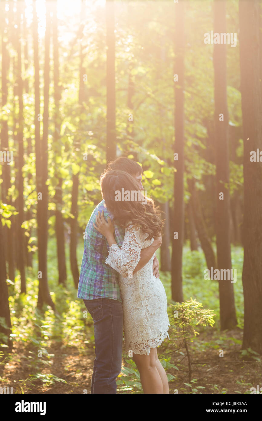 Portrait of a young romantic couple embracing each other on nature ...