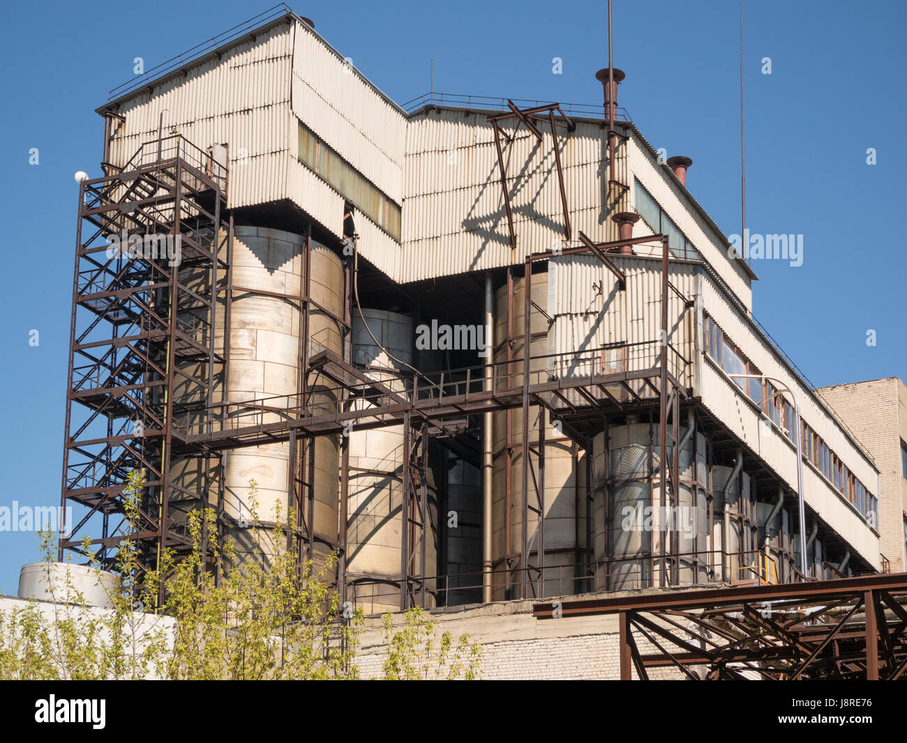 big chemical silos on the plant with blue sky Stock Photo - Alamy