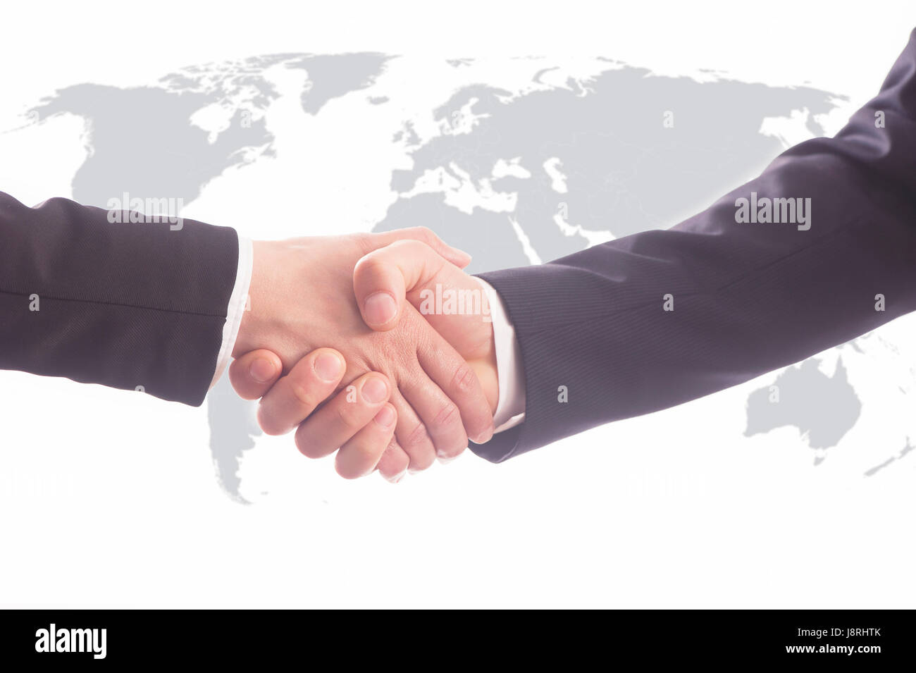 Business partners handshaking after signing hi-res stock photography ...