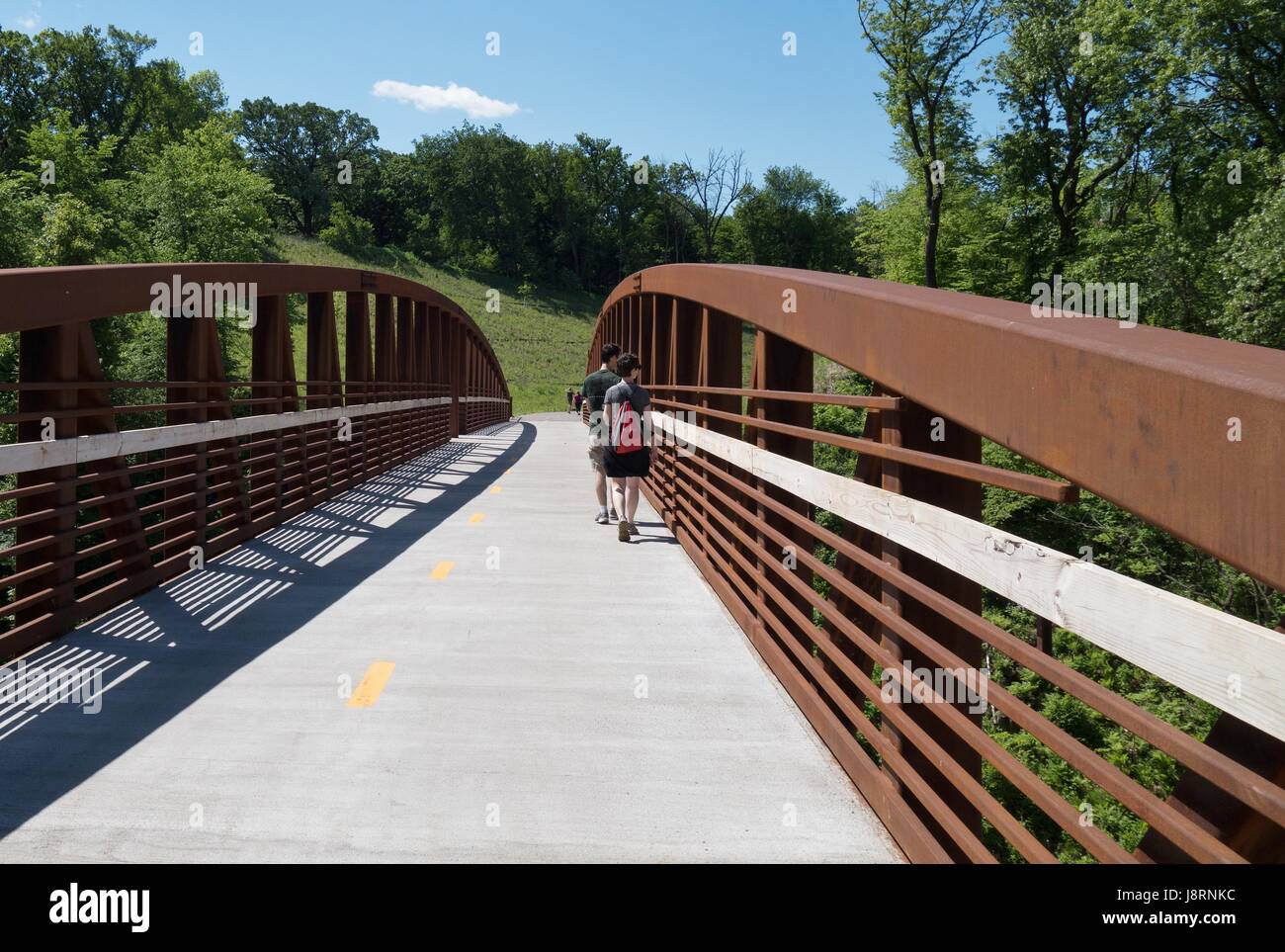 People standing on a bridge at Spring Lake Park Reserve in Hastings ...