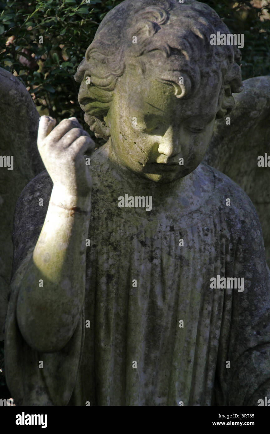 slightly battered angel on a cemetery Stock Photo - Alamy