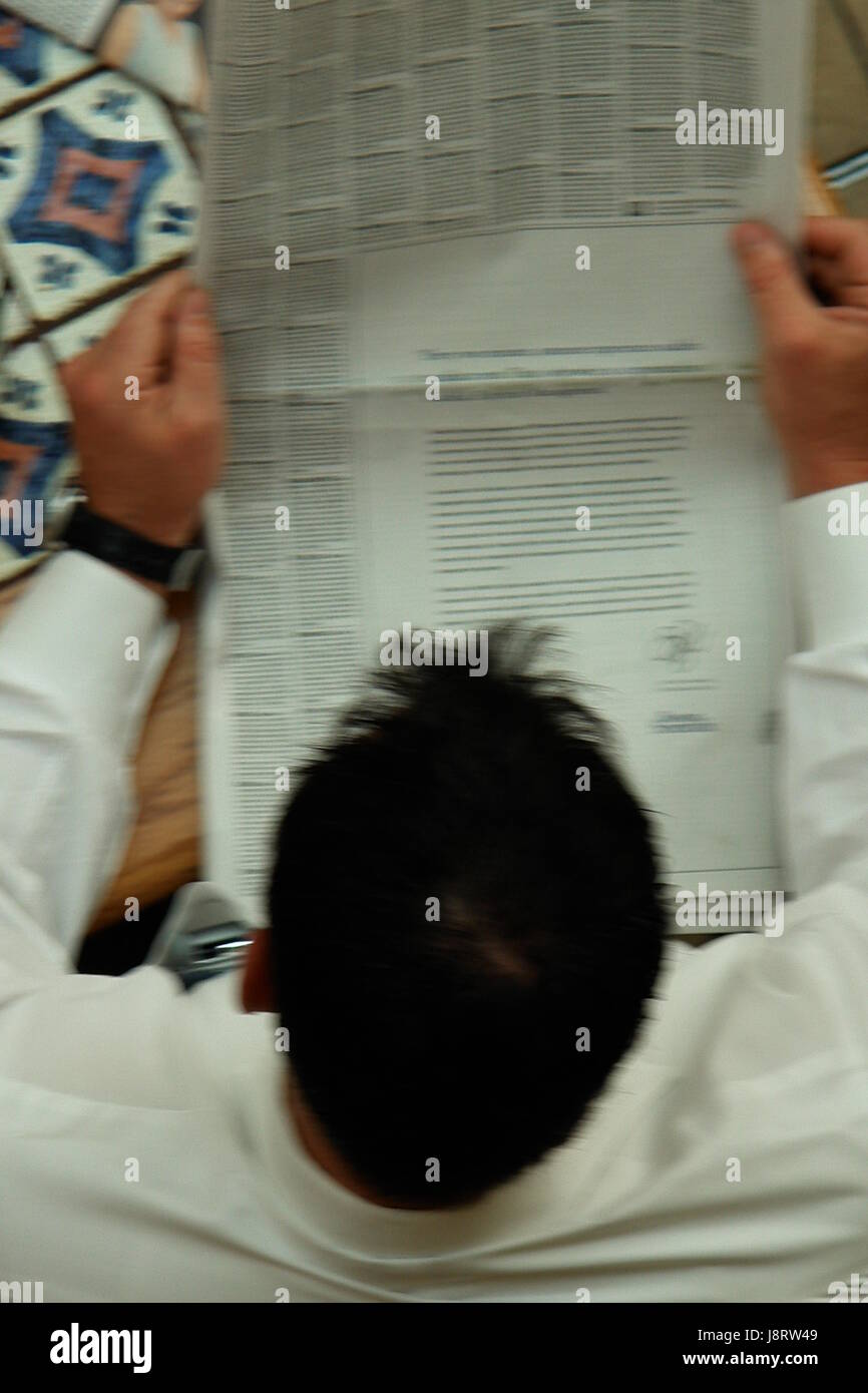 Man reading newspaper view from above Stock Photo - Alamy