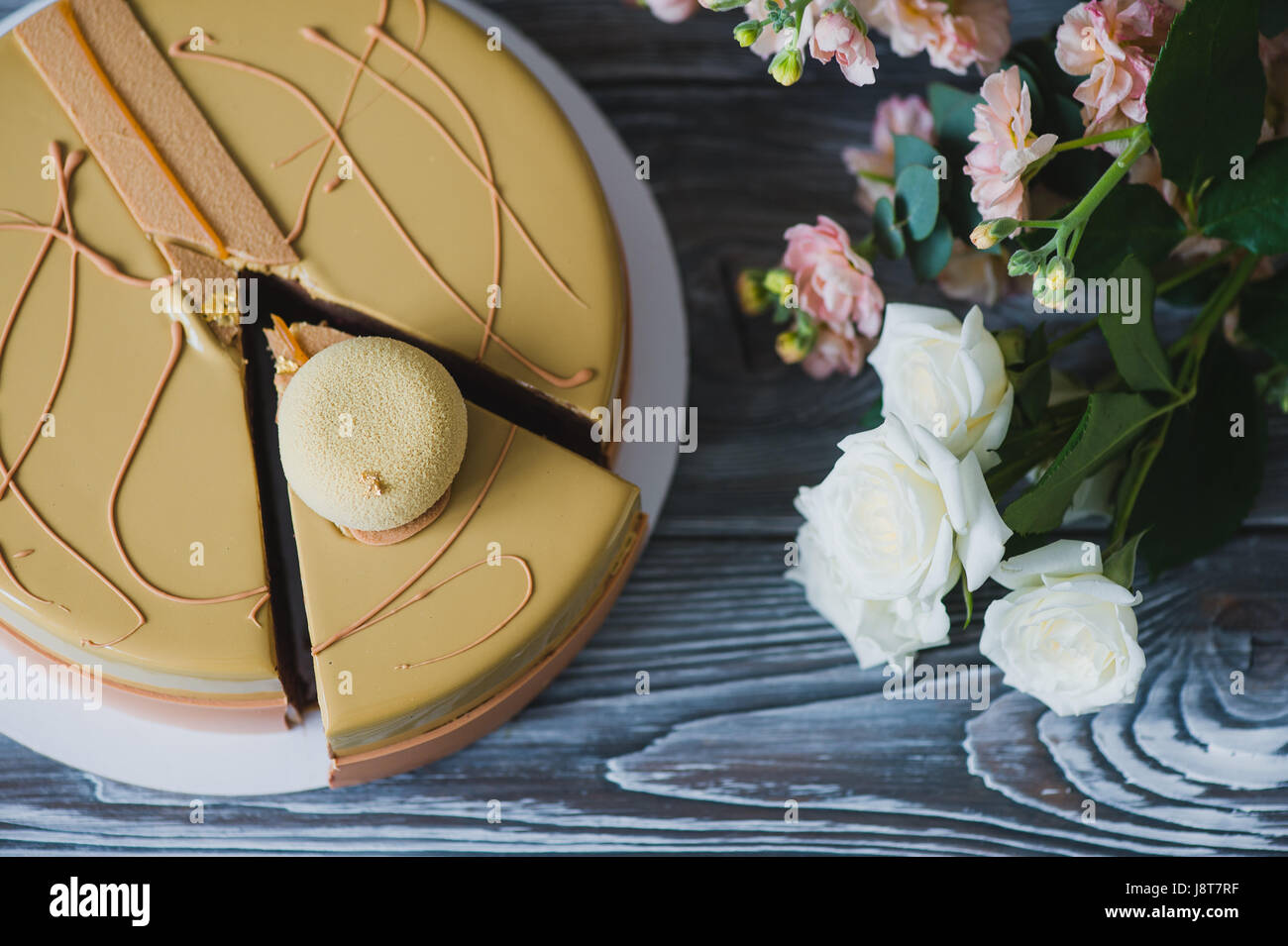 Bakery with piece of unusual yellow mousse cake with almond dacquoise ...