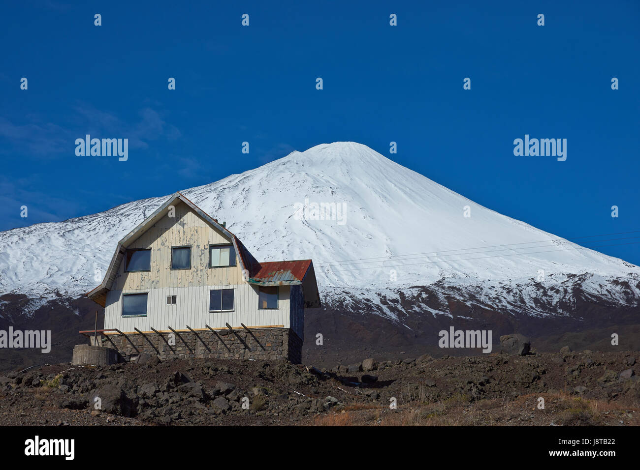 Snow capped peak of Antuco Volcano (2,979 metres) rising above the ...