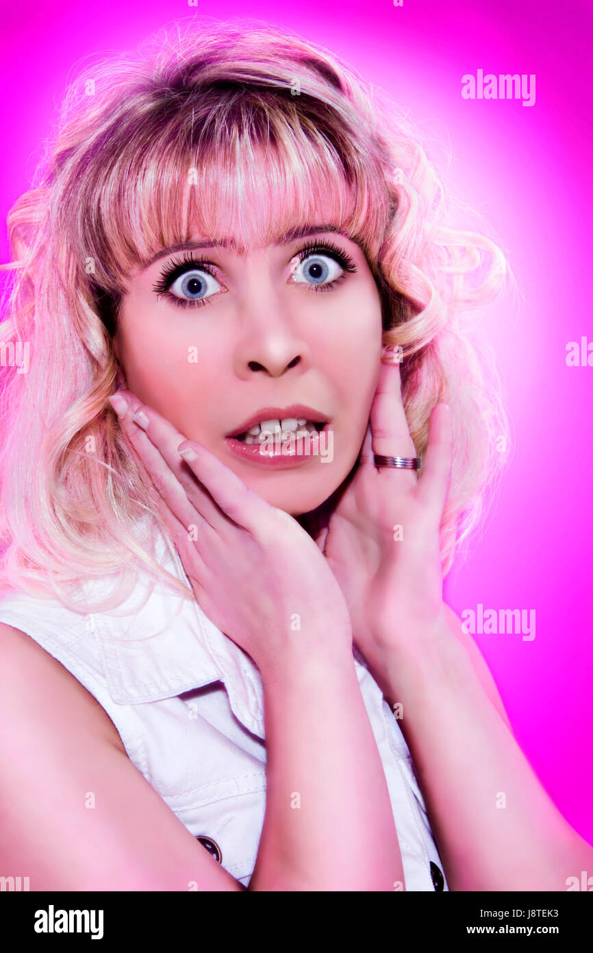 woman looks shocked in pink Stock Photo - Alamy