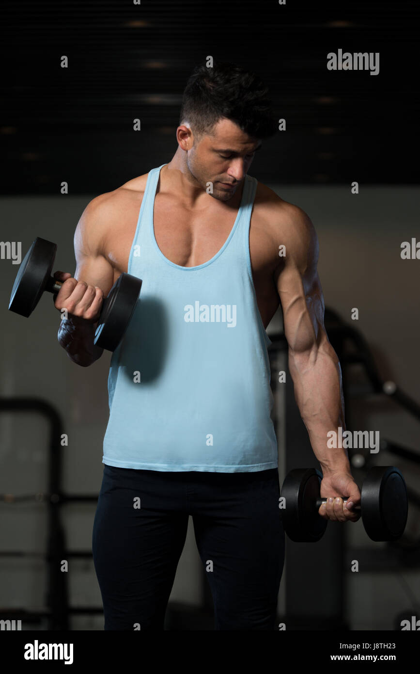 Healthy Man Working Out Biceps In A Fitness Center Gym - Dumbbell ...