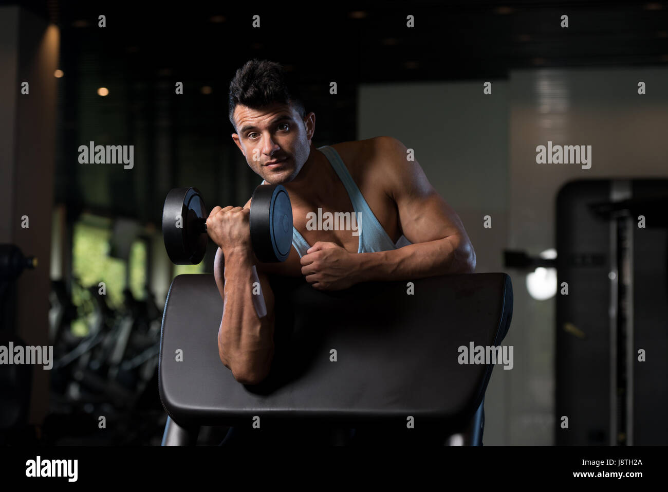 Healthy Man Working Out Biceps In A Fitness Center Gym - Dumbbell ...