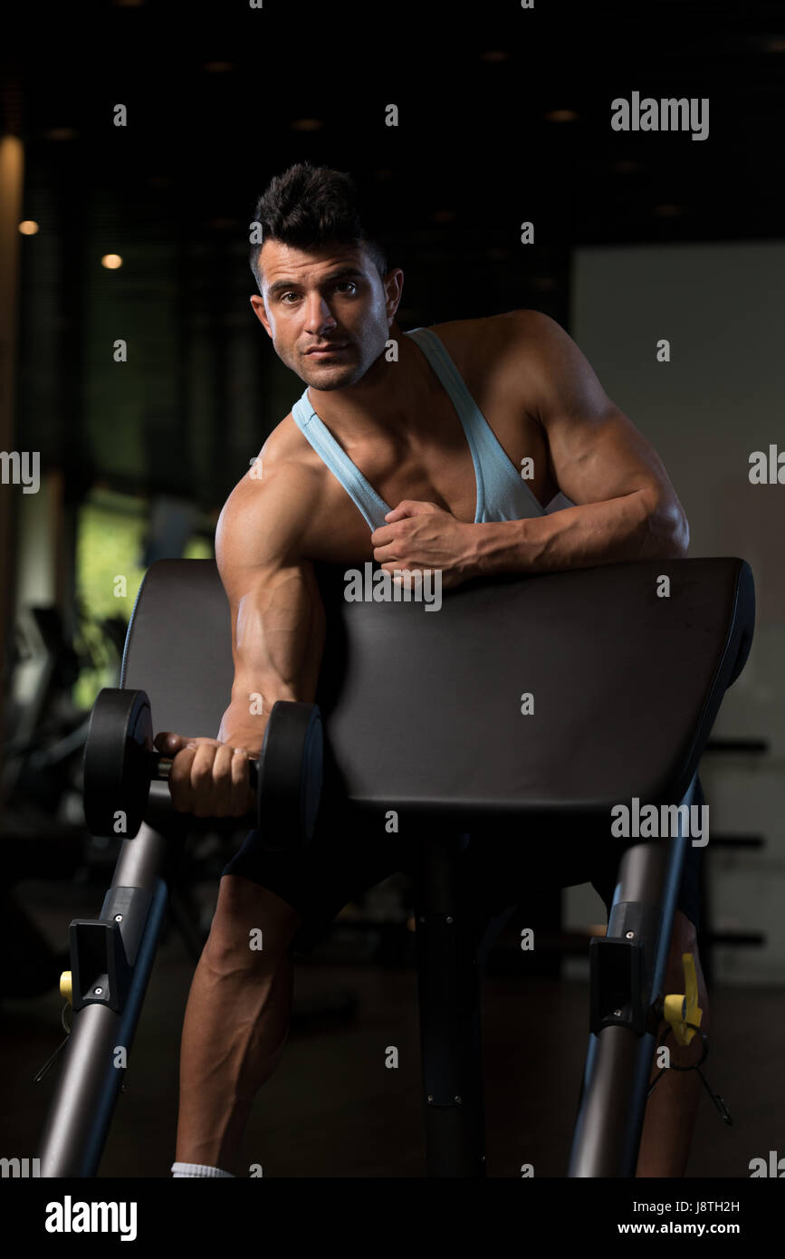 Healthy Man Working Out Biceps In A Fitness Center Gym - Dumbbell ...