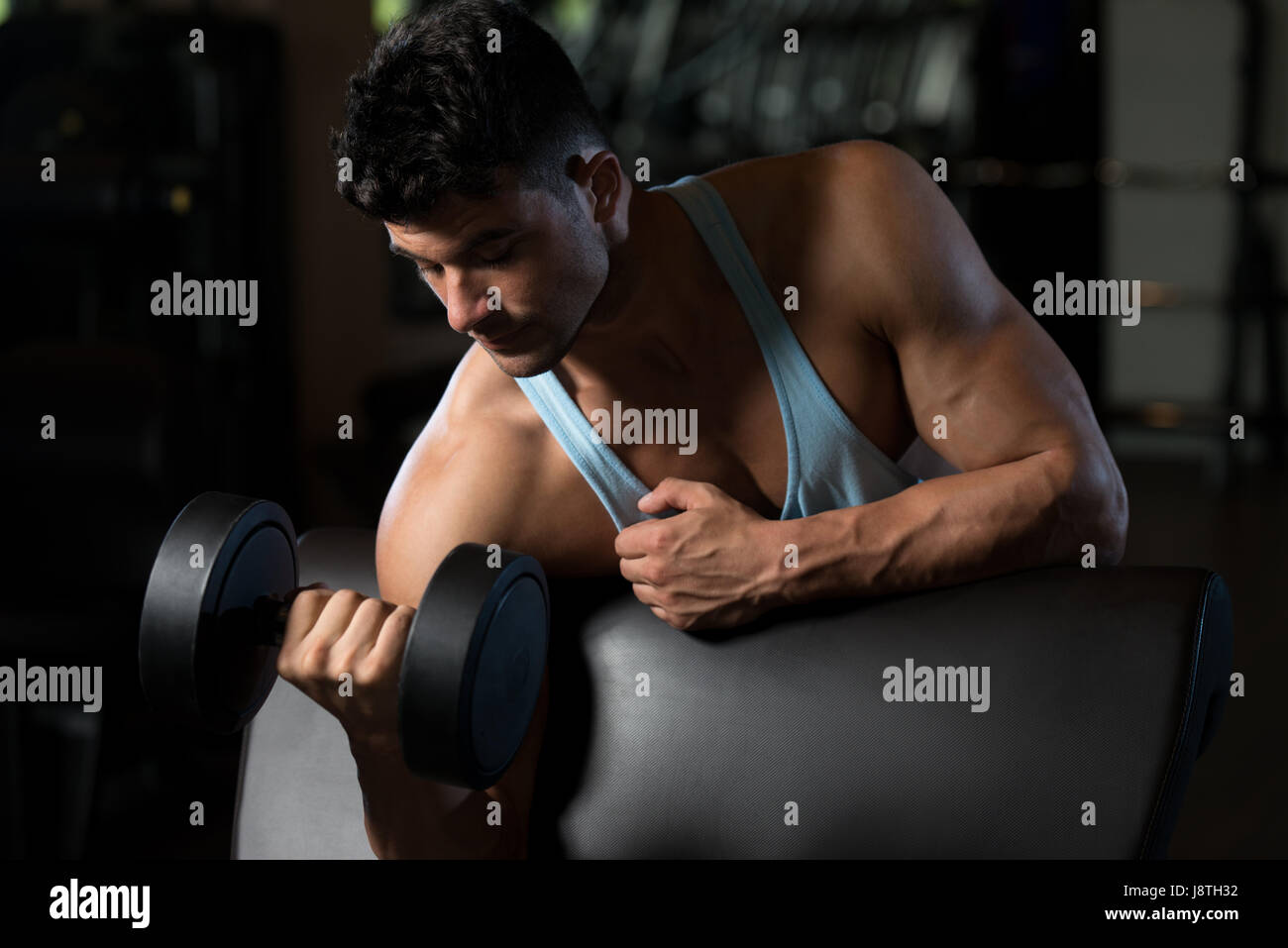 Healthy Man Working Out Biceps In A Fitness Center Gym - Dumbbell ...