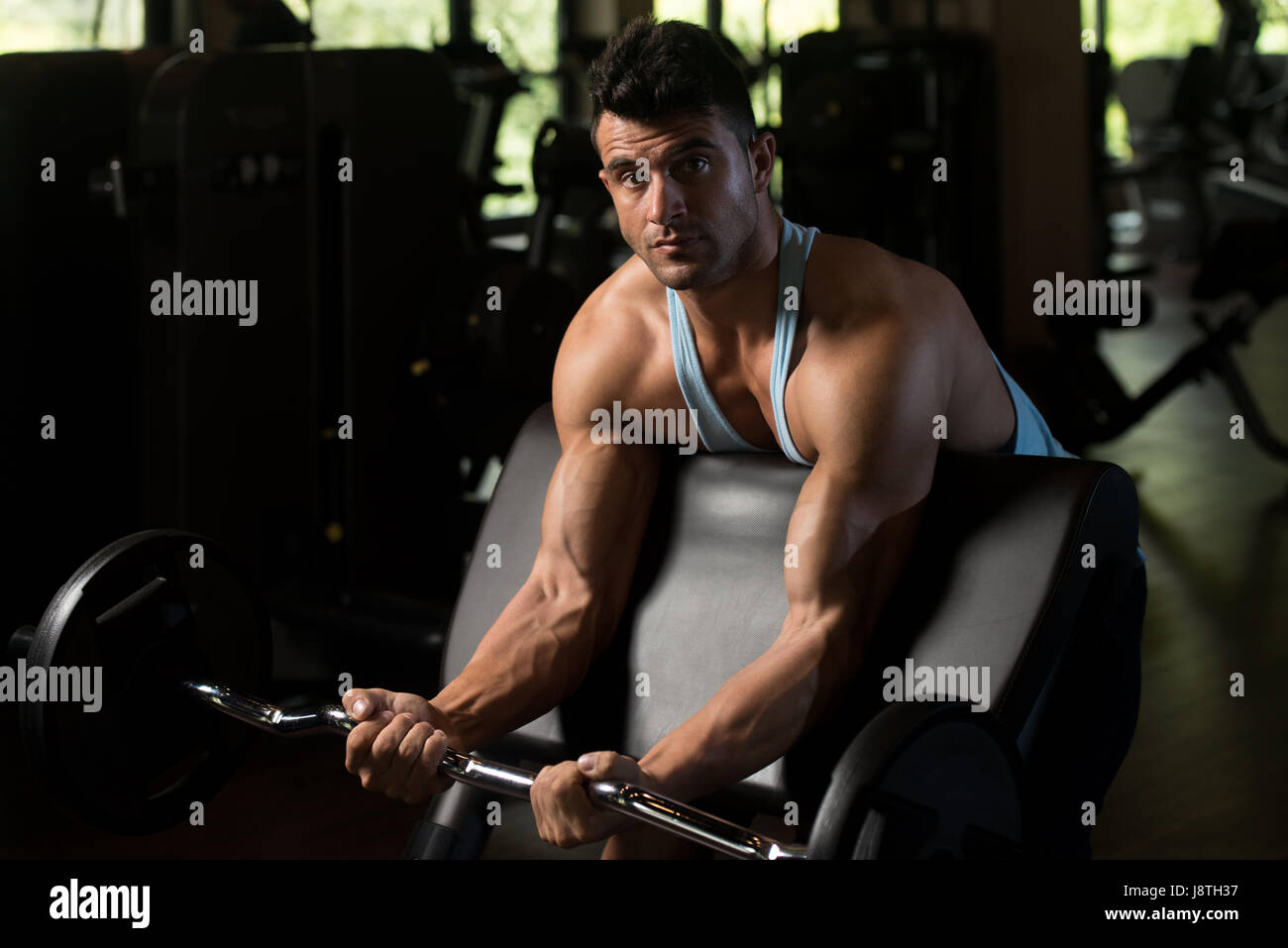 Healthy Man Working Out Biceps In A Fitness Center Gym Stock Photo - Alamy