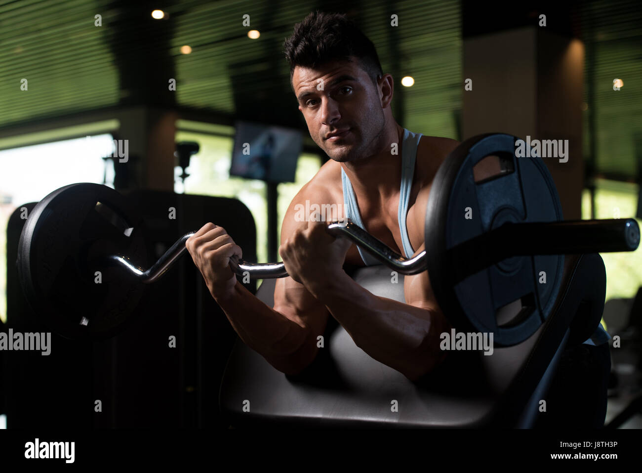Healthy Man Working Out Biceps In A Fitness Center Gym Stock Photo - Alamy