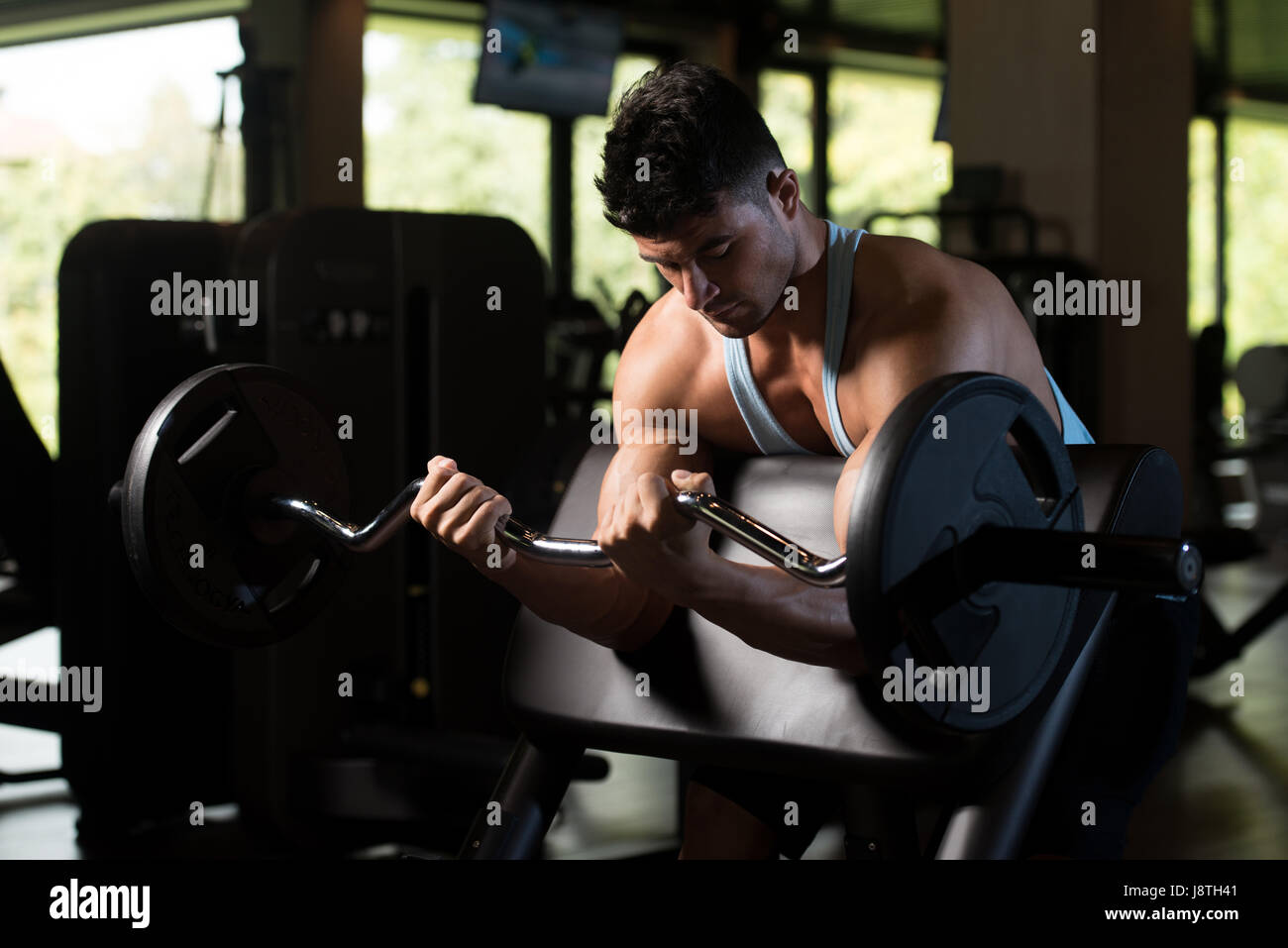 Healthy Man Working Out Biceps In A Fitness Center Gym Stock Photo - Alamy