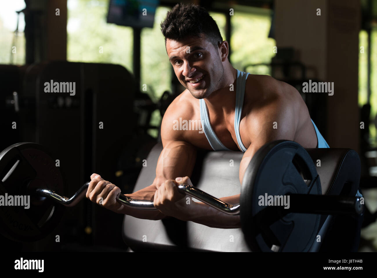 Healthy Man Working Out Biceps In A Fitness Center Gym Stock Photo - Alamy