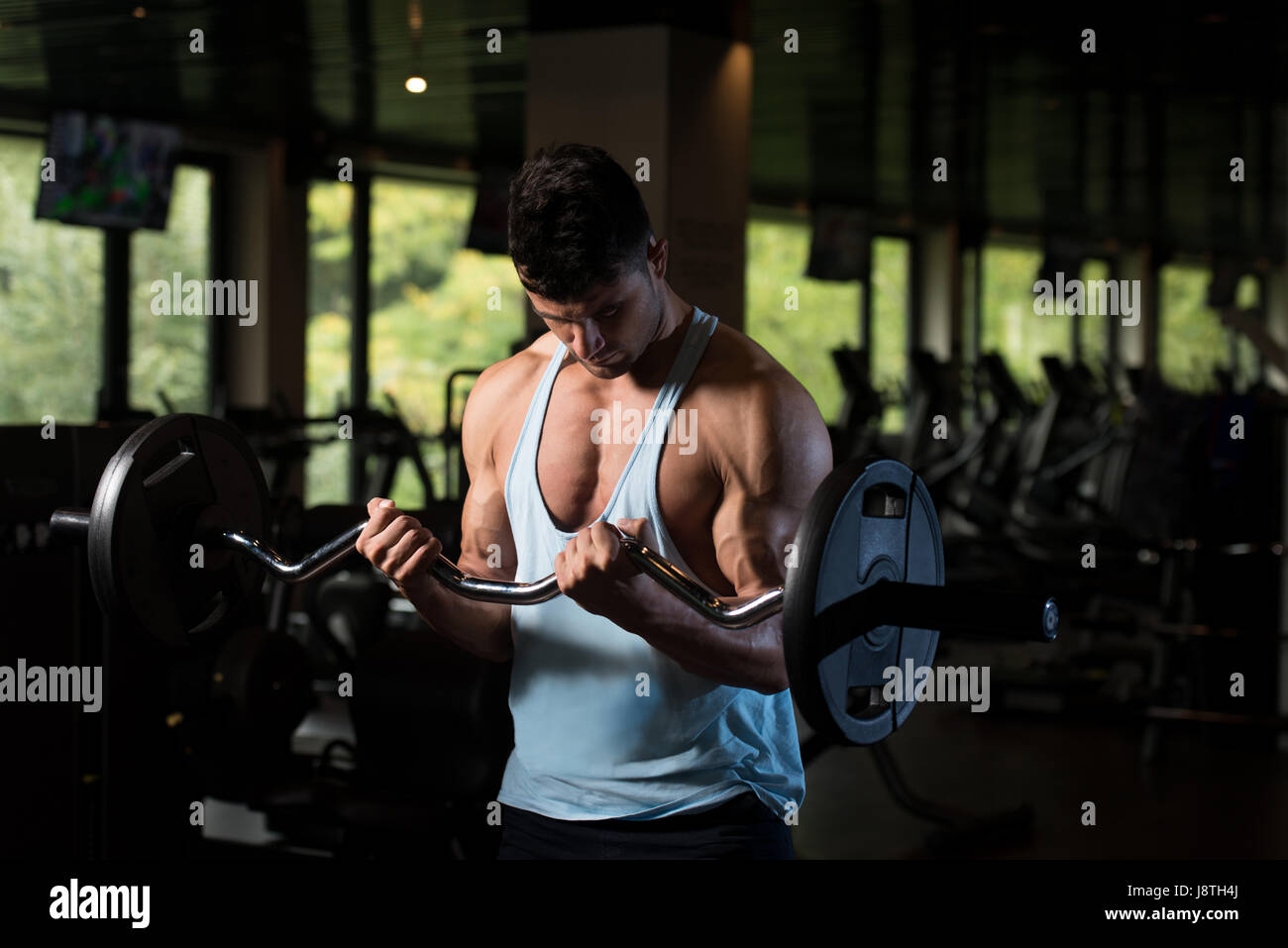 Healthy Man Working Out Biceps In A Fitness Center Gym Stock Photo - Alamy