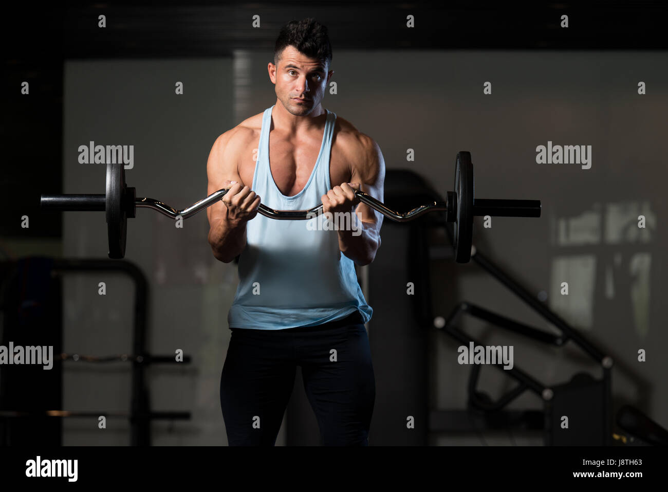 Healthy Man Working Out Biceps In A Fitness Center Gym Stock Photo - Alamy