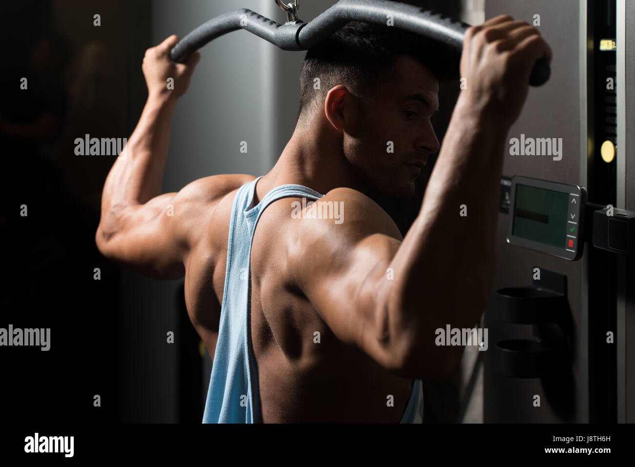 Muscular Man Doing Heavy Weight Exercise For Back On Machine Stock ...