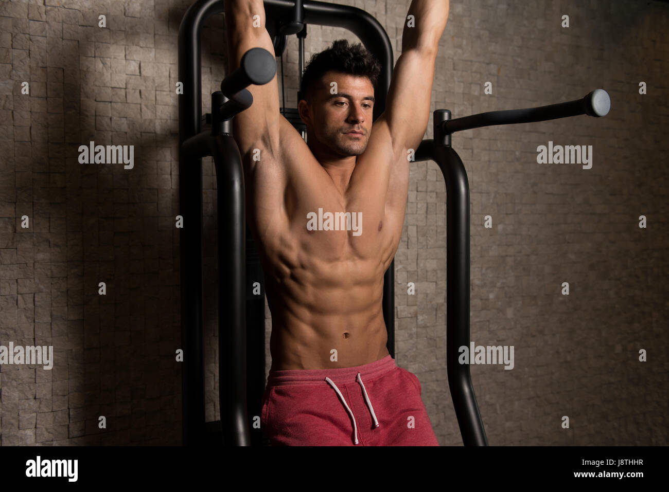 Man Performing Hanging Leg Raises Exercise - One Of The Most Effective ...