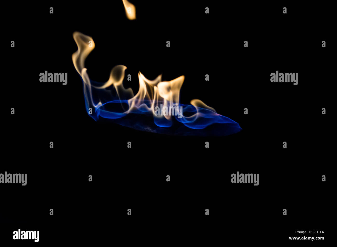 Fire with blue flame base and orange flames towards top with circular ...