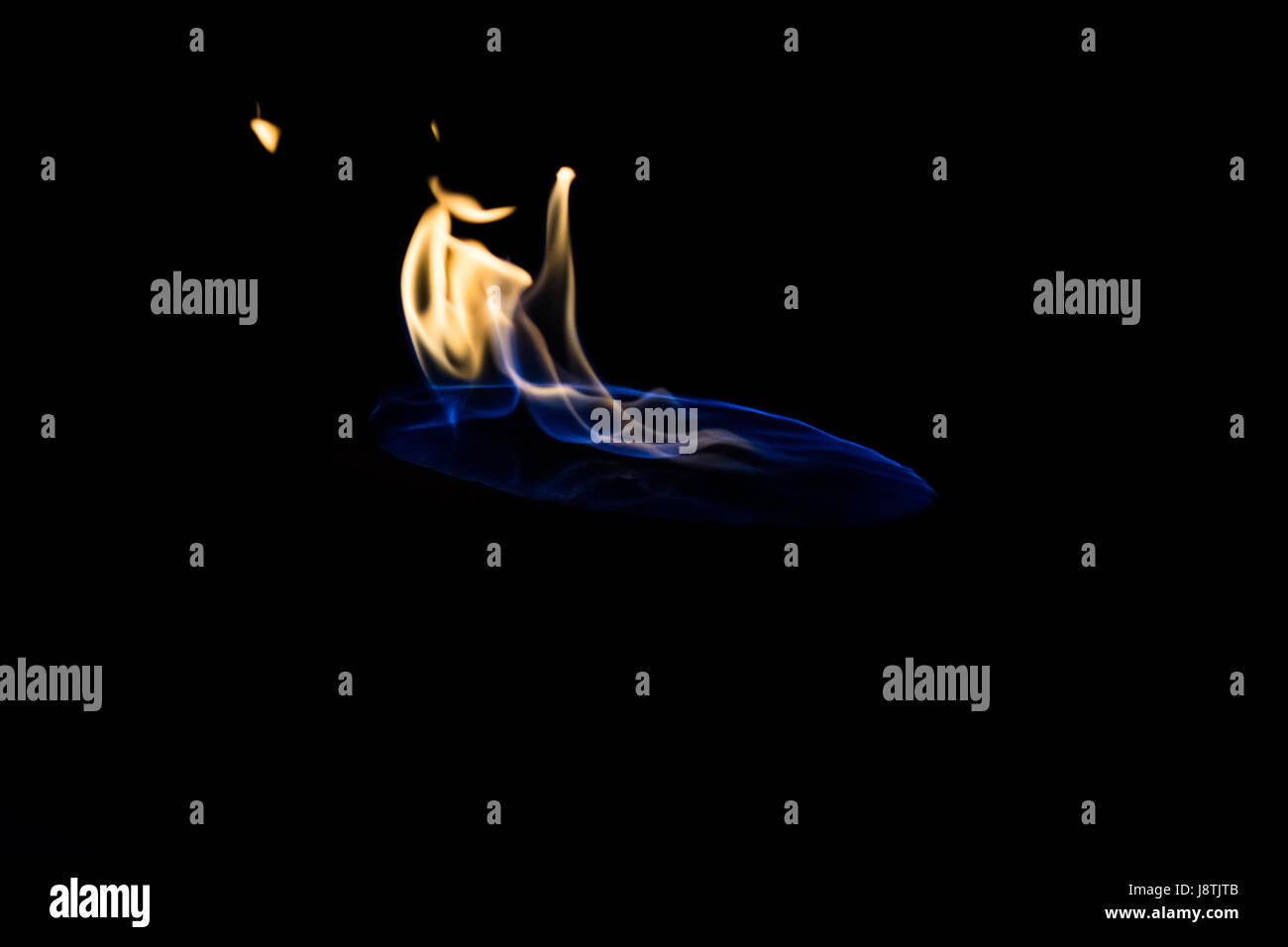 Fire with blue flame base and orange flames towards top with circular ...