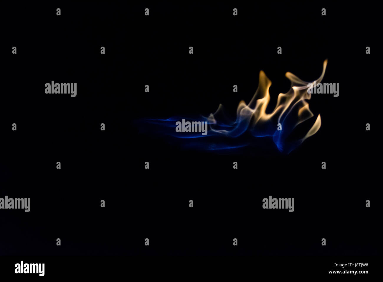 Fire with blue flame base and orange flames towards top with circular ...