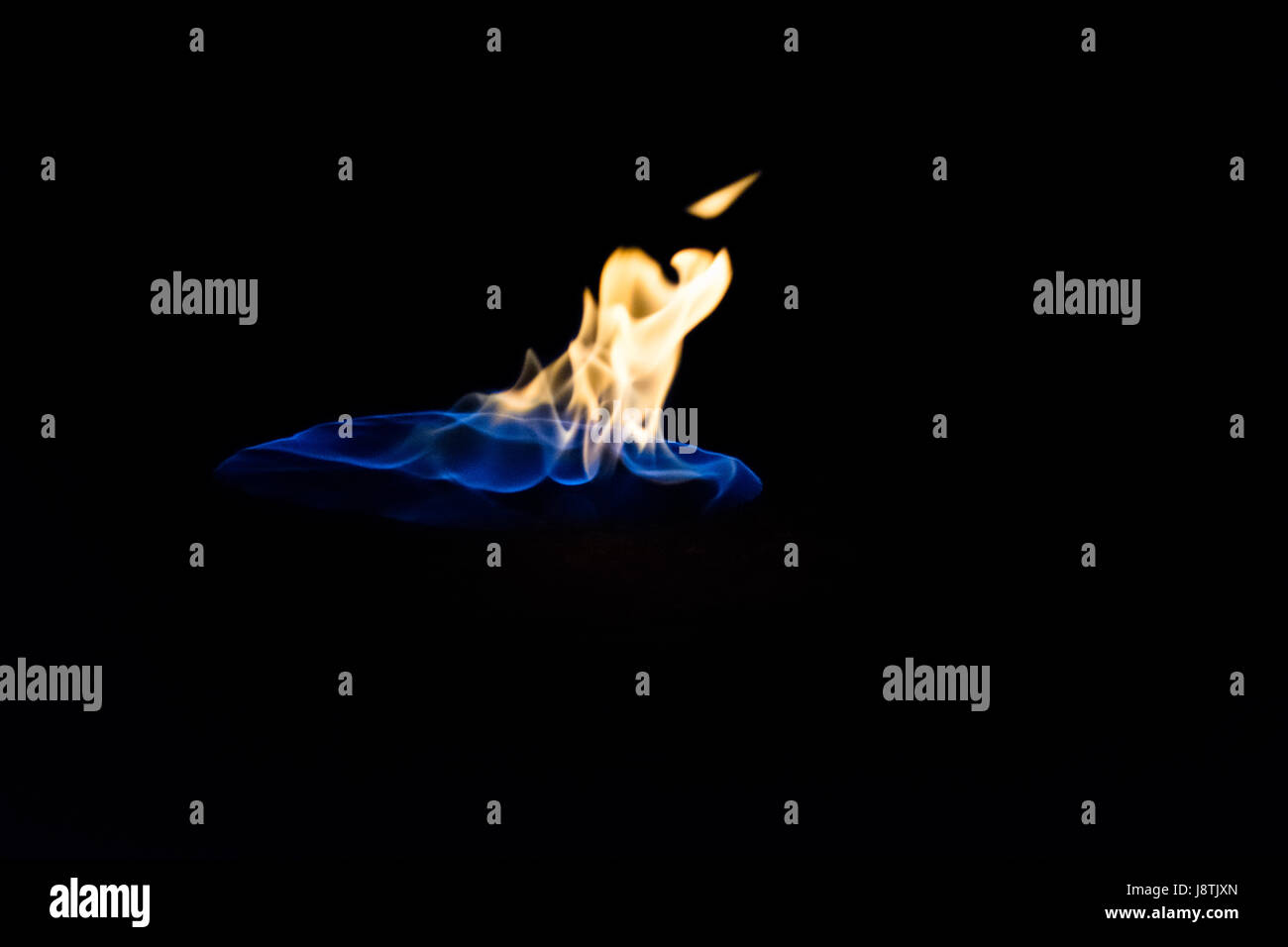 Fire with blue flame base and orange flames towards top with circular ...