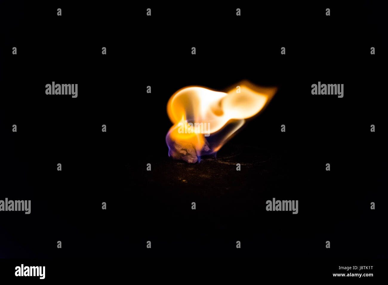 Fire with blue flame base and orange flames towards top with circular ...