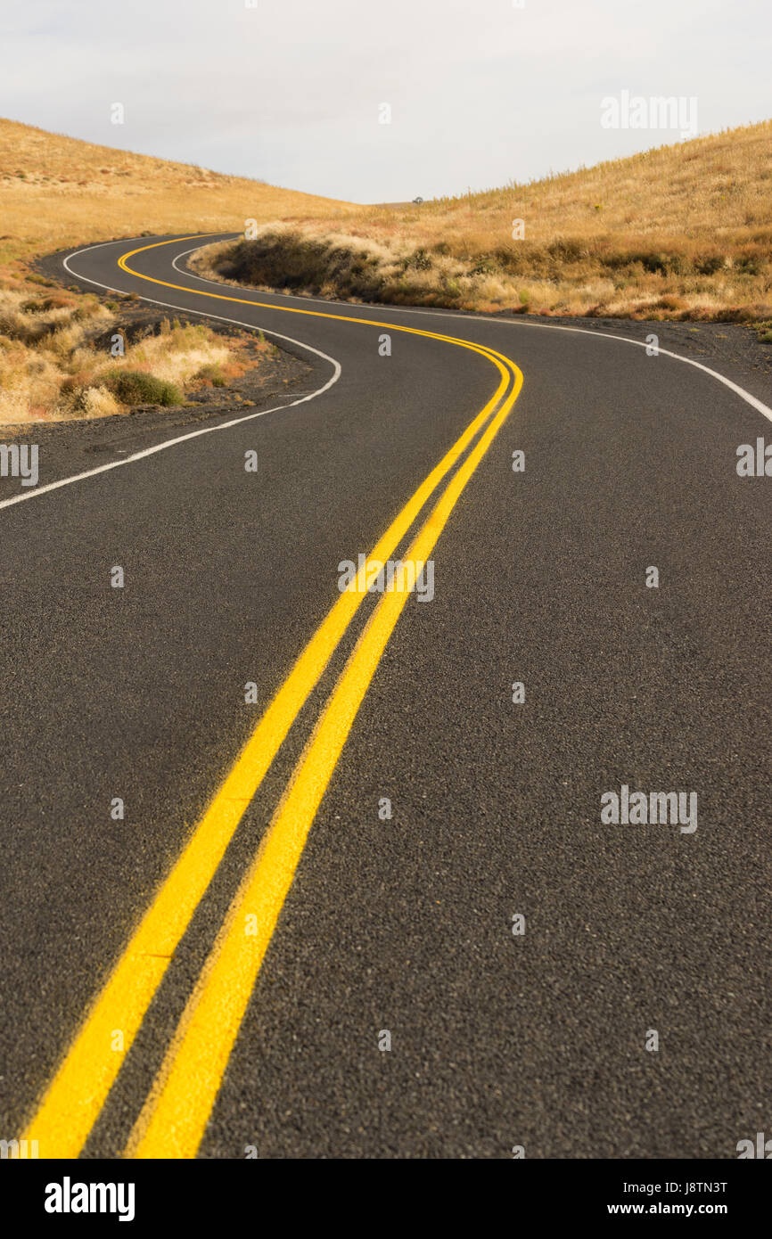 A well preserved two lane road leads around a bend to an interesting ...