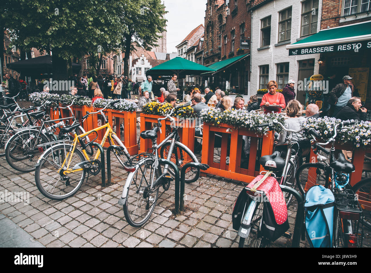 Bikes lined up outside a crowded restaurant in Bruges (Brygge), Belgium ...