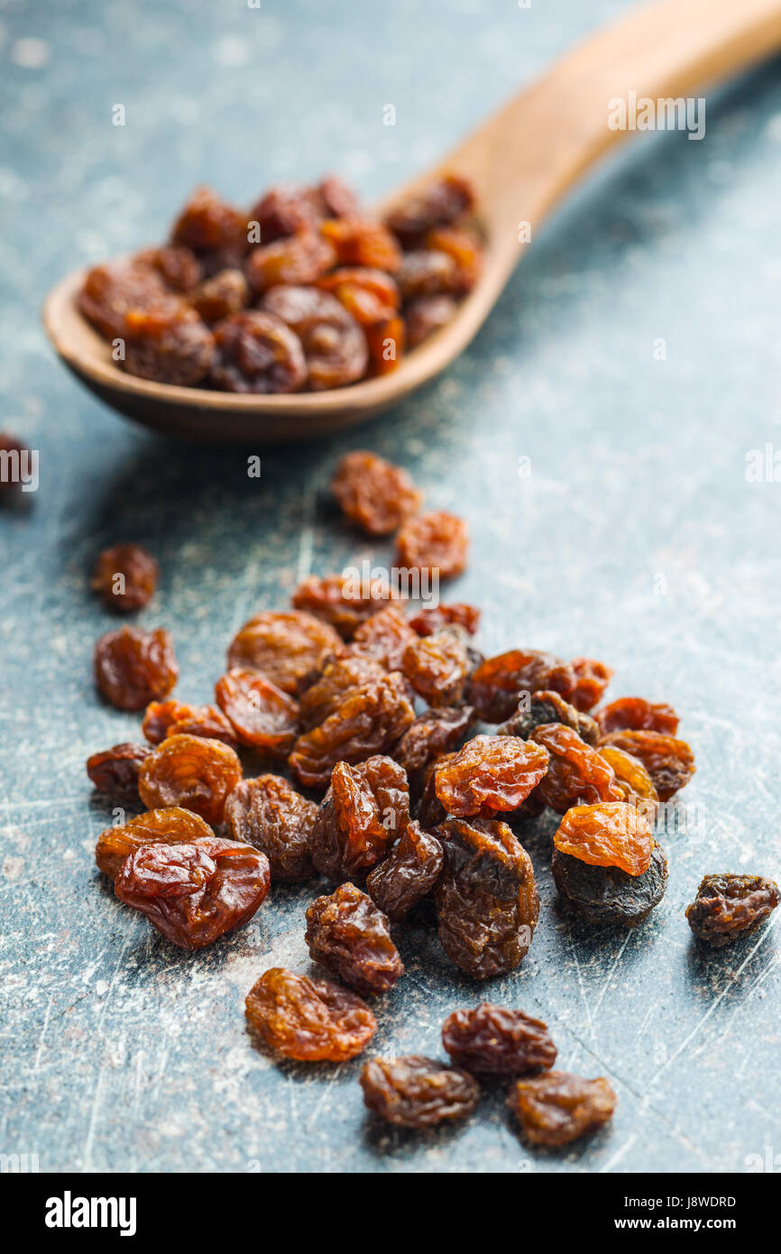 Sweet dried raisins on old kitchen table Stock Photo - Alamy