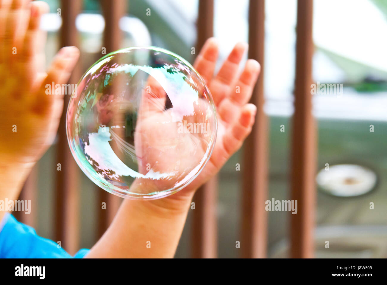 Soap bubbles are floating through in hand of the little children Stock ...
