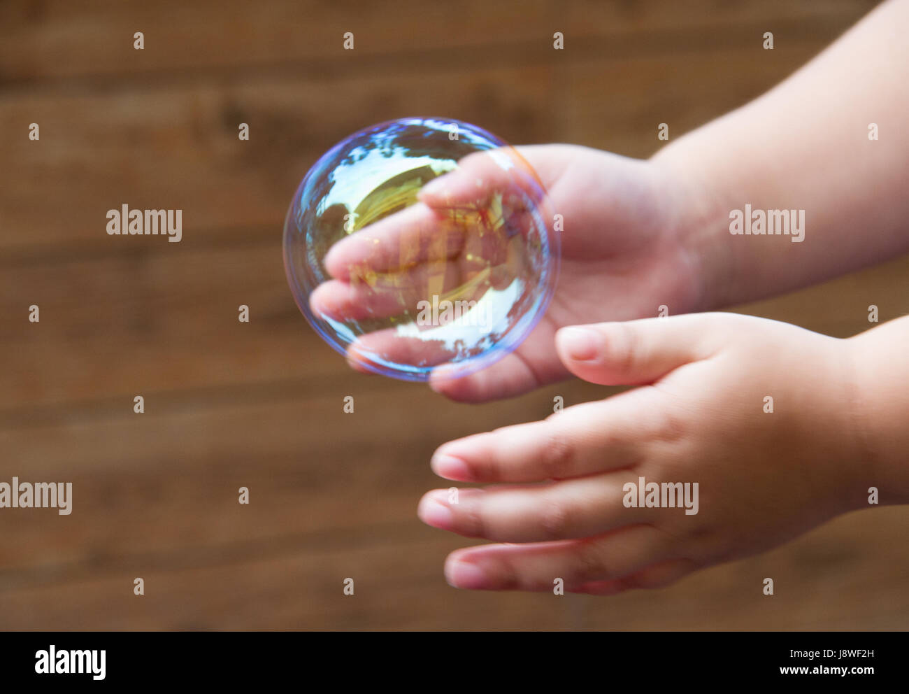 soap bubbles are floating through in hand of the little children Stock ...
