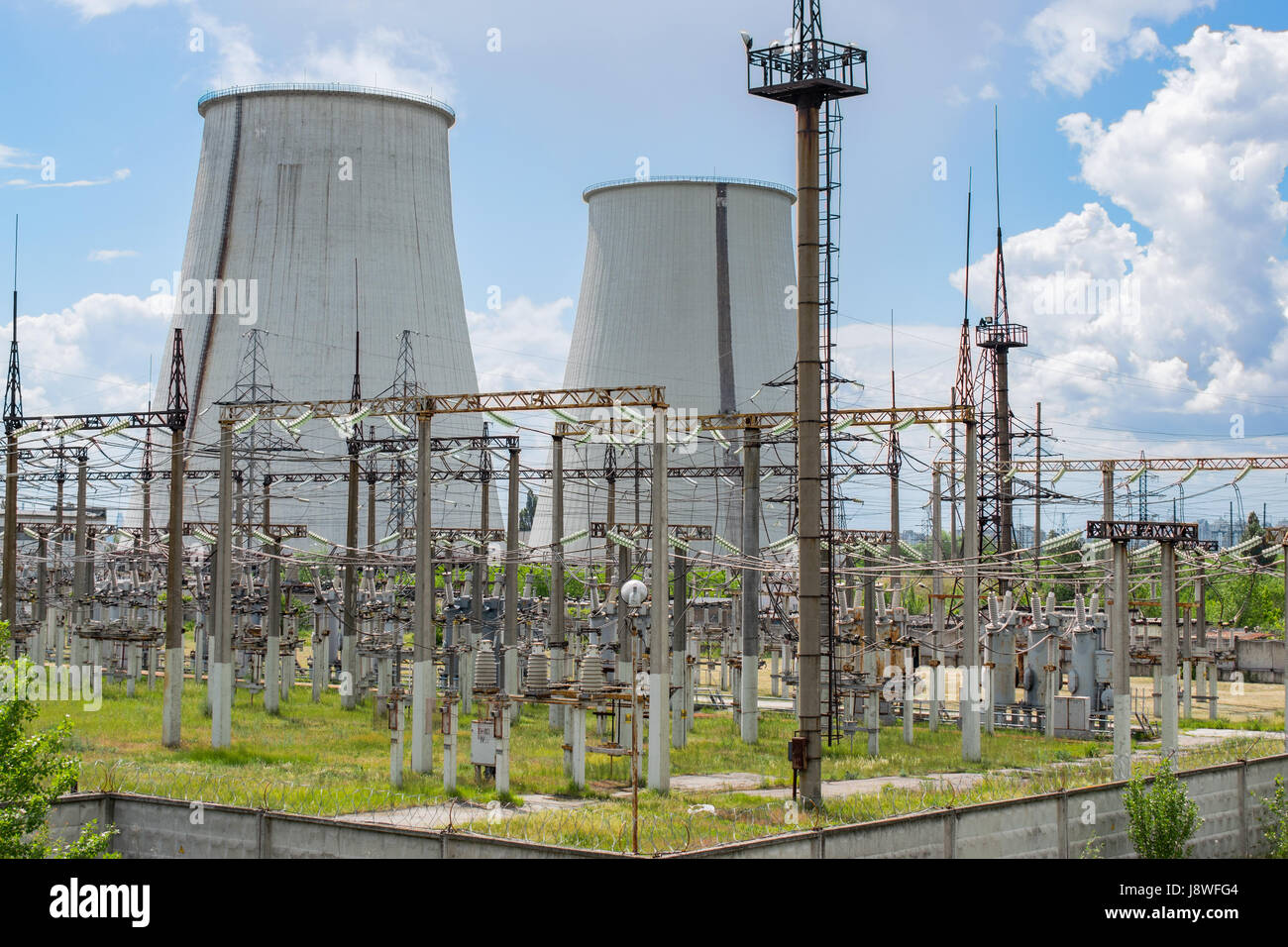 Power plant transformator station with cooling towers on the background ...