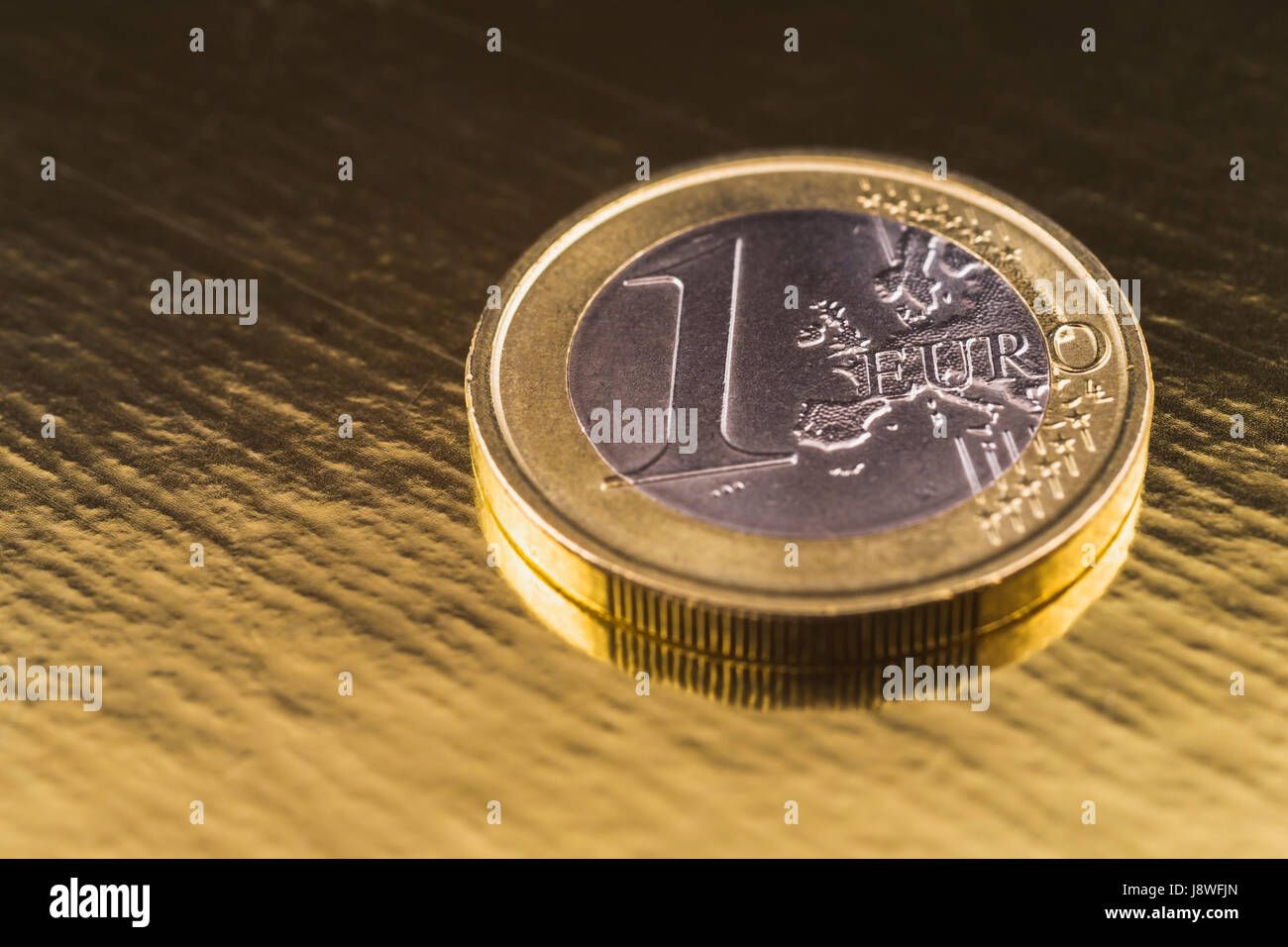 One Euro coin on gold background Stock Photo - Alamy