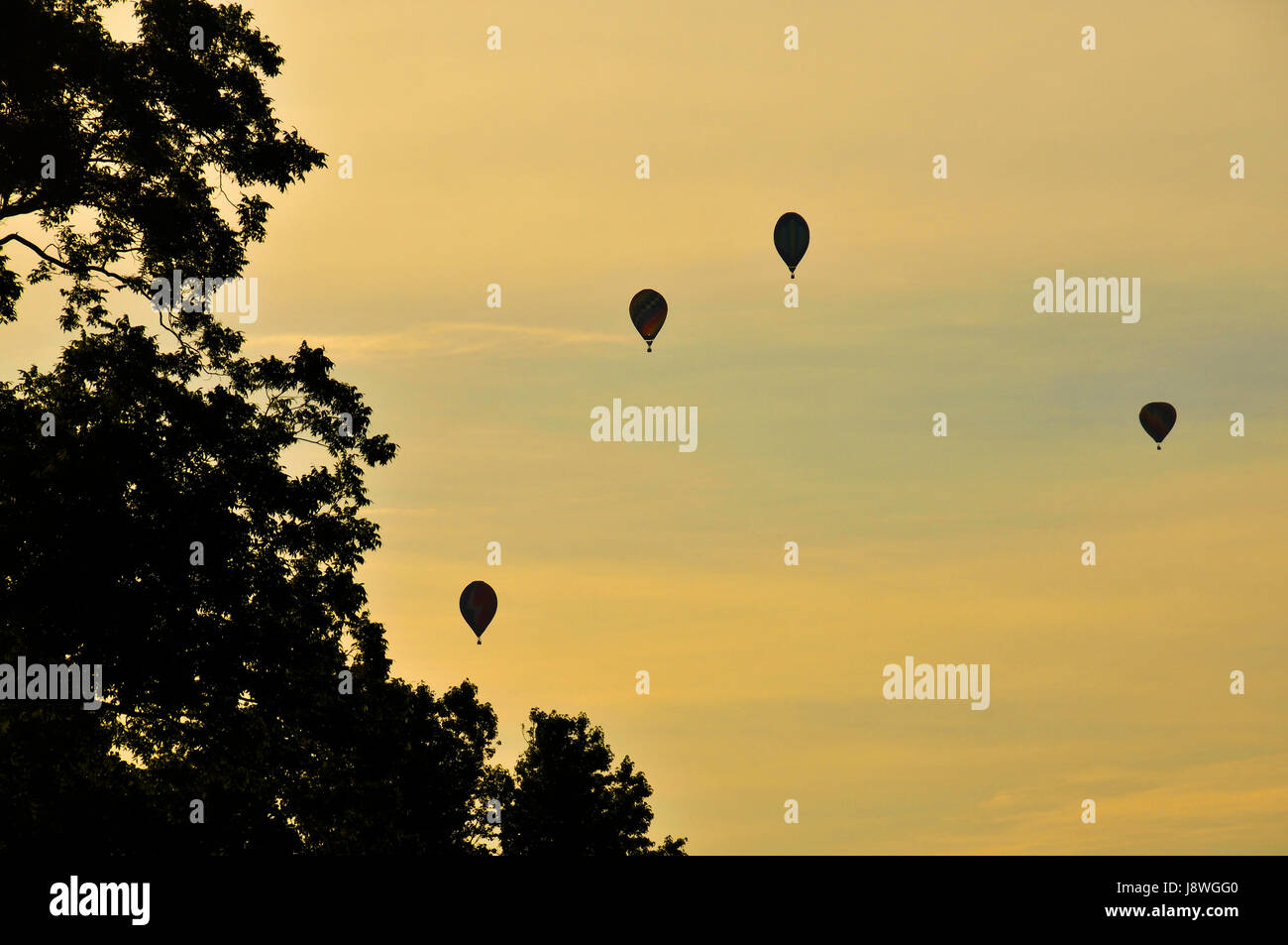 Hot air balloon rising above the horizon Stock Photo - Alamy